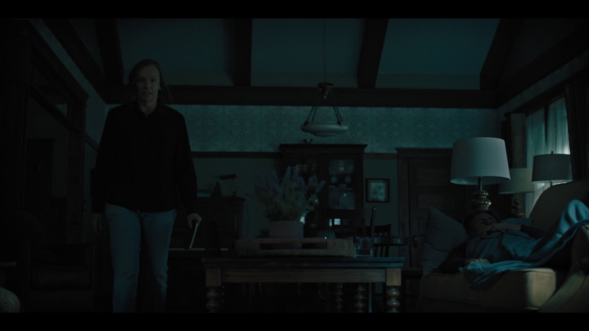 Hereditary – reflection of Annie in glass cupboard