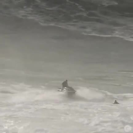 Jet skier saves guy from a tidal wave