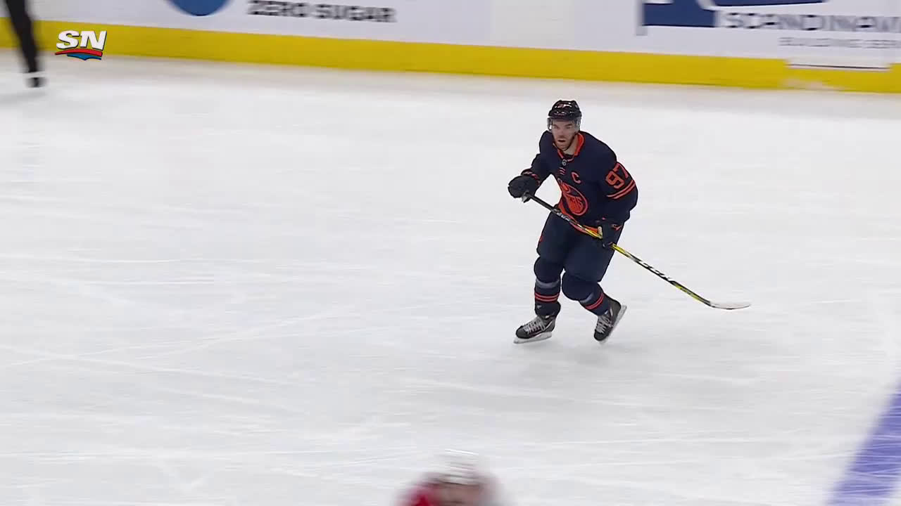 Connor McDavid skates through the neutral zone, splits the defenders ...