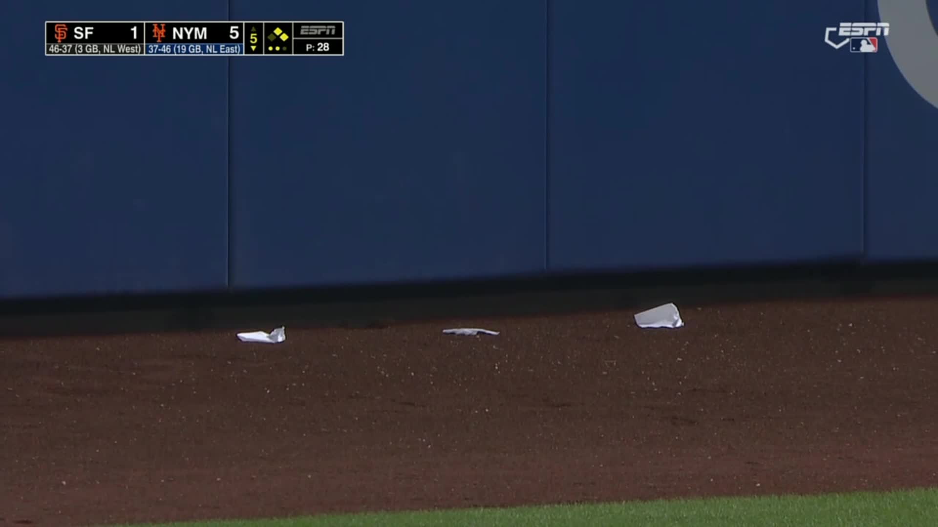 A fan is escorted off the field after falling over the railing in the ...