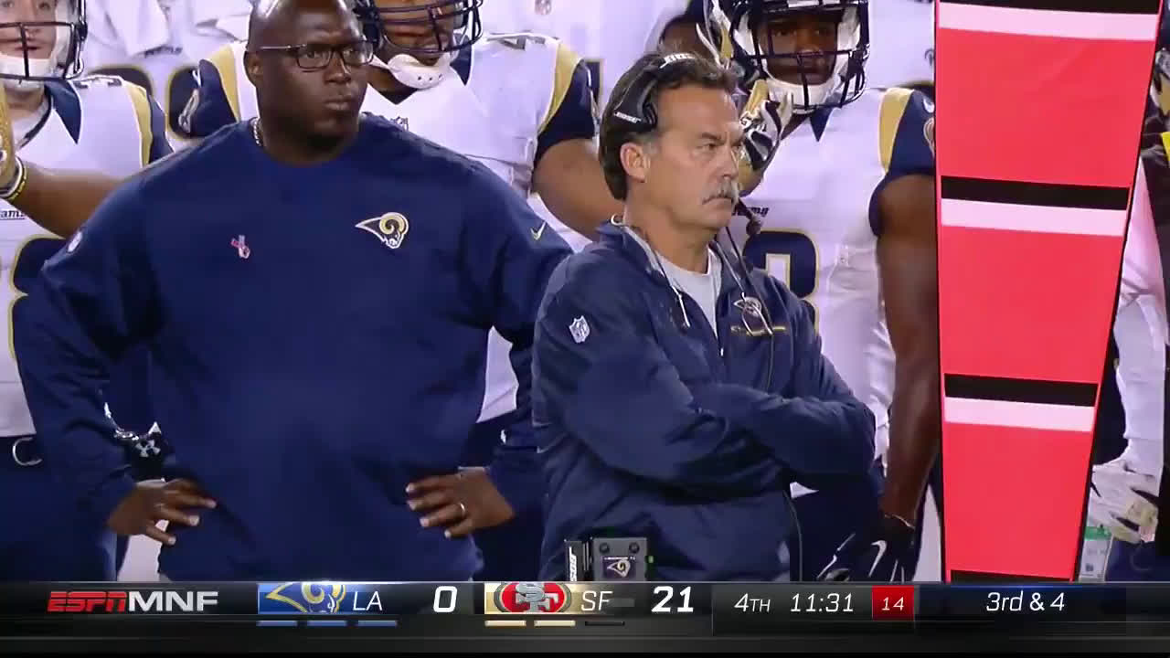 NFL radio announcer Kevin Harlan narrates a streaker running on the field