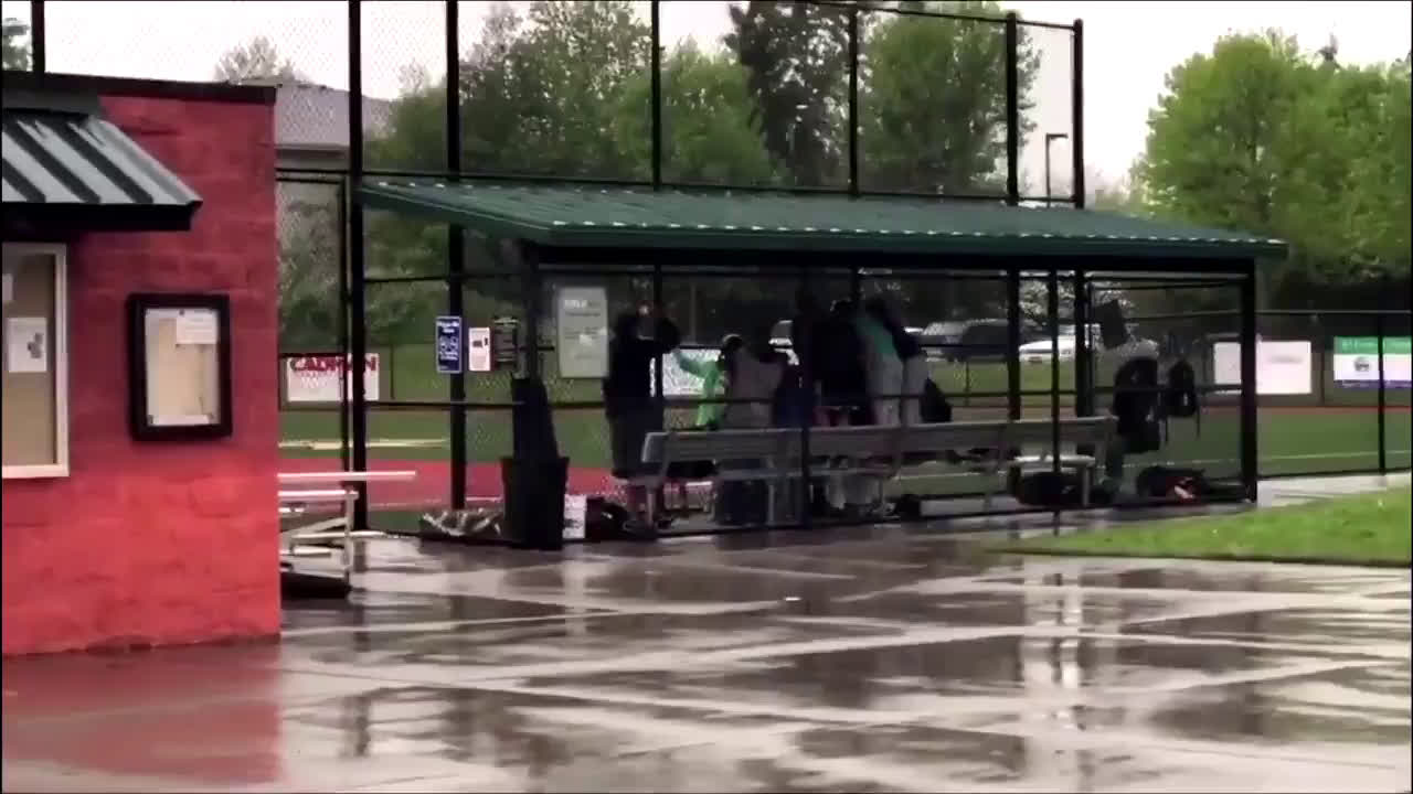 Rained out youth baseball team watches the final pitch of the other day ...